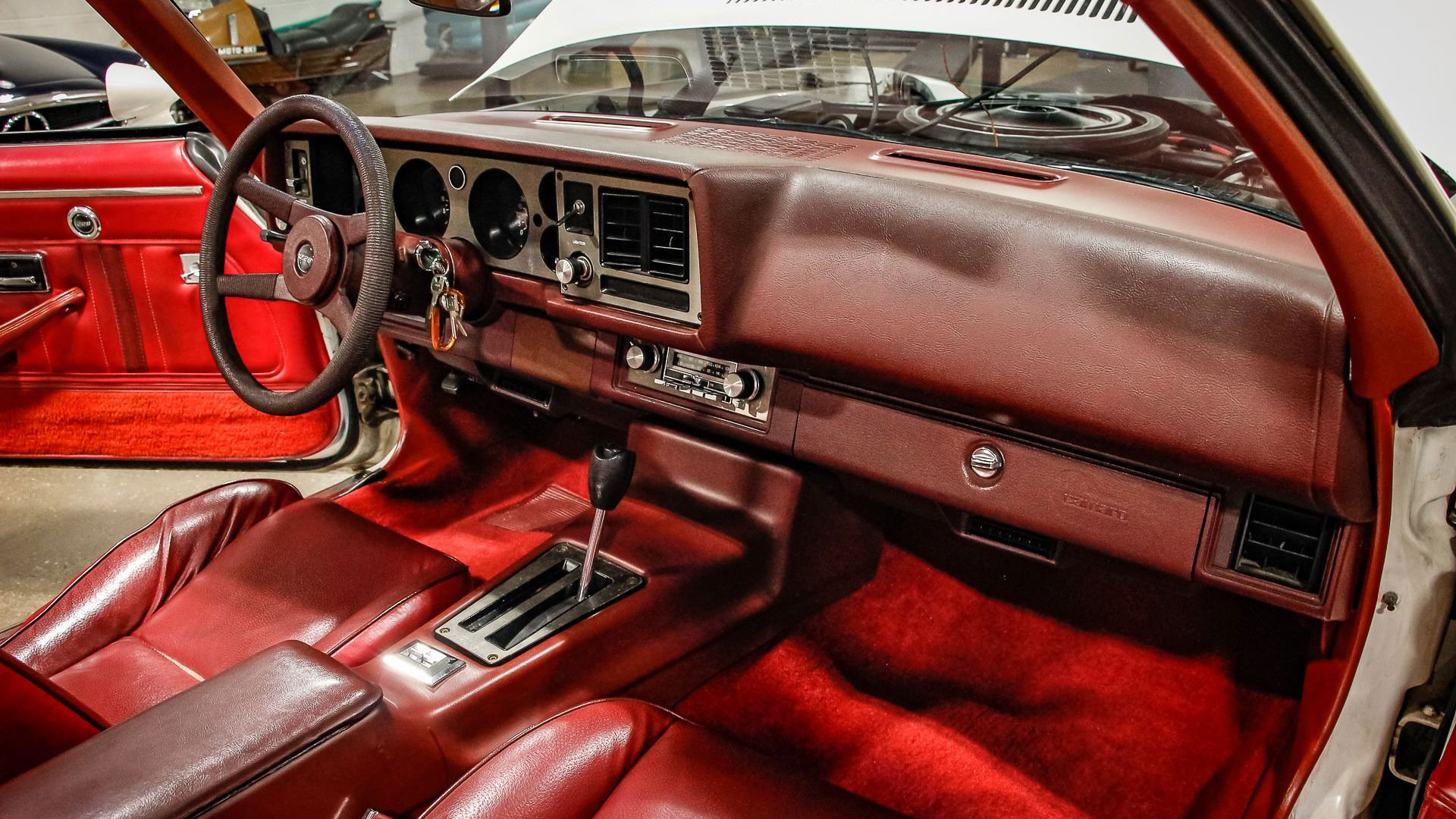 1981 Chevrolet Camaro convertible interior 007 Garage Kept Motors white passenger side seats console steering wheel dash GM Authority